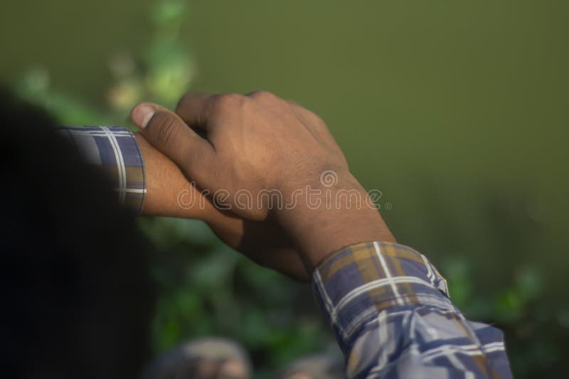Two Hands Holding Each Other of a Man and Blurred Background Stock ...
