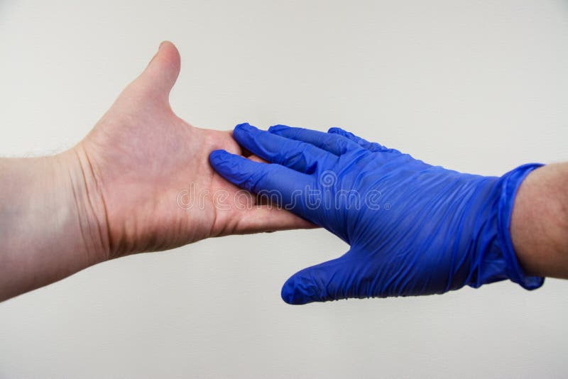 Two Hands, One in a Rubber Protective Glove, Virus Protection Stock ...