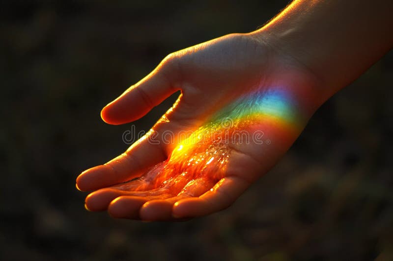 Hands Catch a Rainbow in Sunlight during a Serene Outdoor Moment of ...
