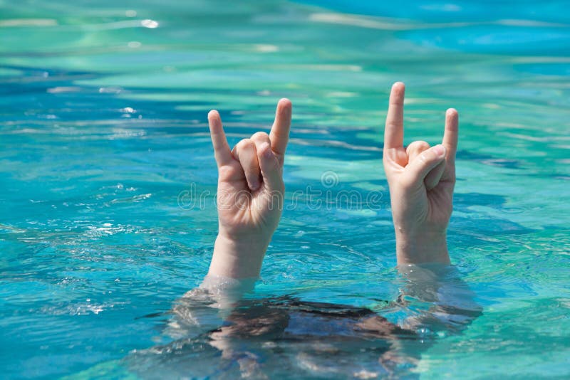 Two Hands Out of Water in Rock Gesture Stock Image - Image of rescue ...