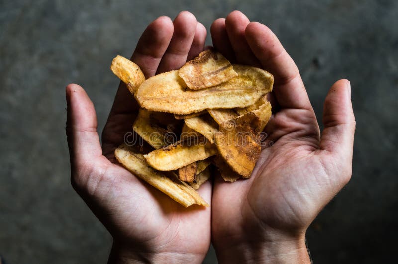 Two Hands Presenting Delicious Banana Chips Stock Image - Image of chip ...