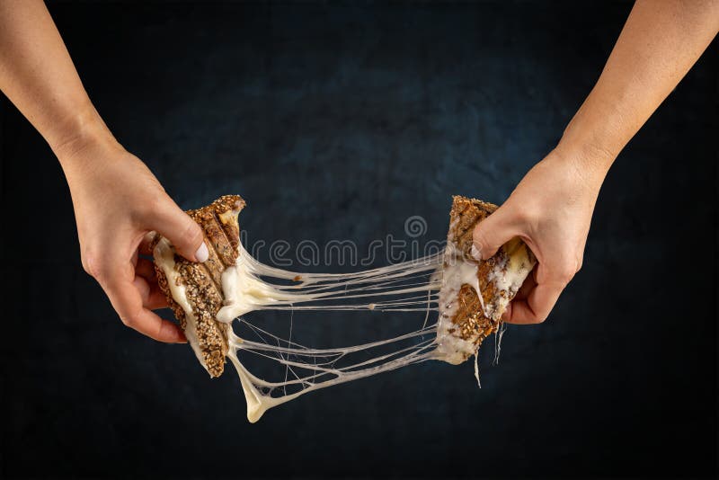 Two Hands Pulling Apart a Grilled Cheese Stock Image - Image of hands ...