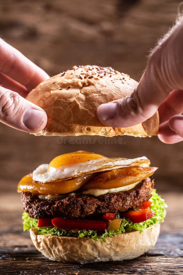 Two Hands Put the Top Bun Part on Freshly Made Beef Burger Stock Image ...