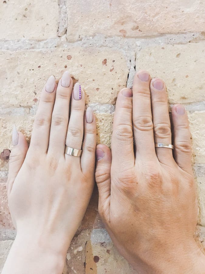 Two Hands with Rings on a Light Brick Wall Stock Photo - Image of wall ...