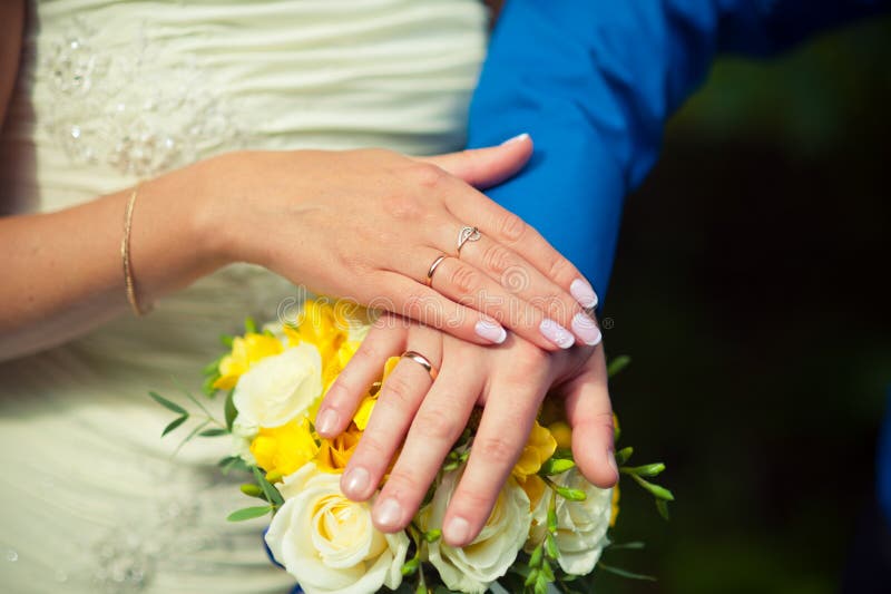 Two Hands with Wedding Rings on Bouquet of Bride Stock Photo - Image of ...
