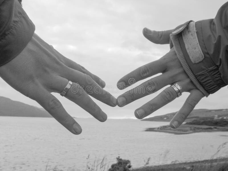 Two Hands with Wedding Rings and Ocean in Background - Wedding ...