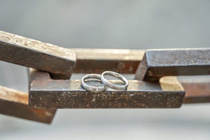 Two Hands with Wedding Rings Rest on a Strong Anchor Chain Stock Photo ...