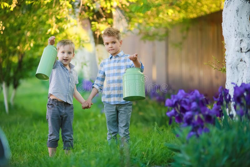 Two Handsome Brothers Having Fun while Sitting Outside in Garden Stock ...