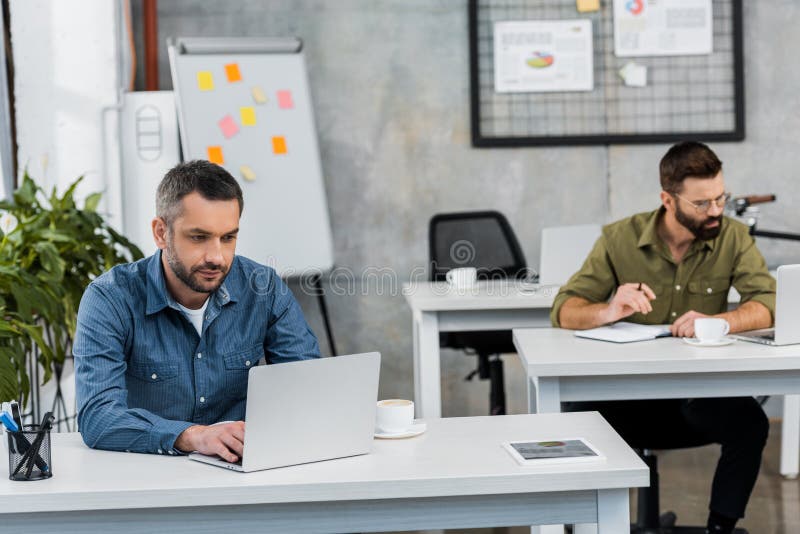 Two Handsome Businessmen Working at Laptops Stock Image - Image of ...