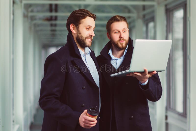Two Handsome Businessmen Working Together on a Project at Lobby Stock ...