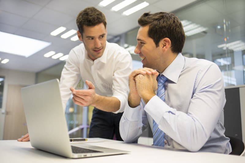 Two Handsome Businessmen Working Together on a Project in the of Stock ...