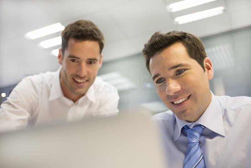 Two Handsome Businessmen Working Together on a Project in the of Stock ...
