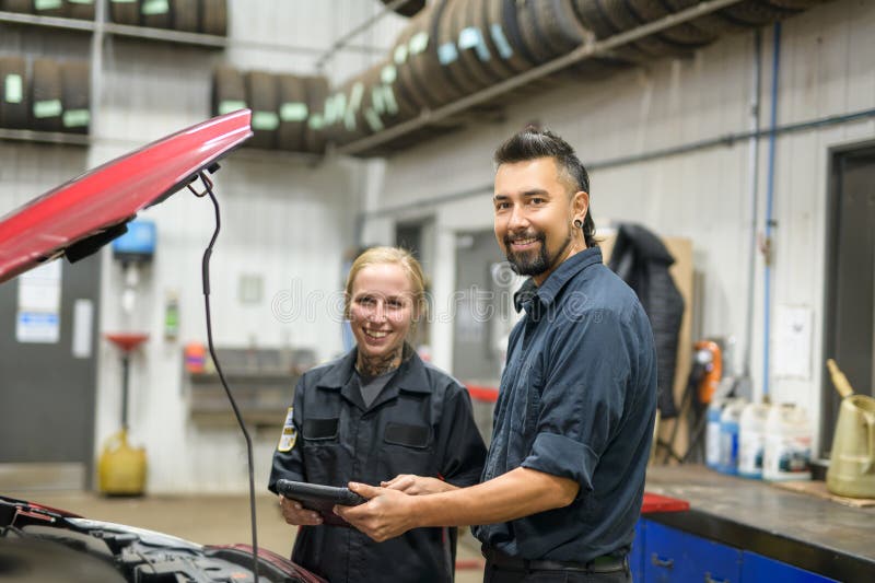 Two Handsome Mechanic Worker in Uniform Working on Car with Tablet ...