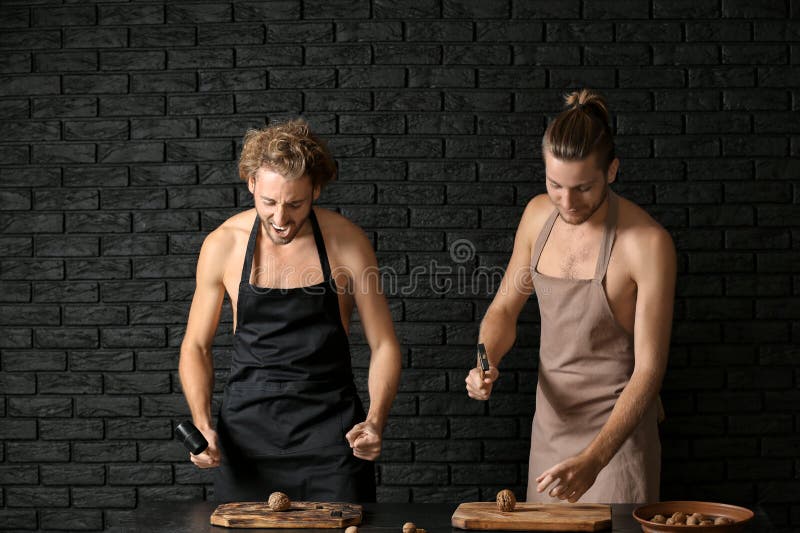Two Handsome Men Cracking Walnuts. Concept of Hard Nut To Crack Stock ...