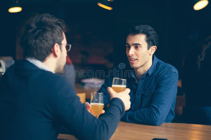 Two Handsome Men in Pub stock photo. Image of beverage - 51105866