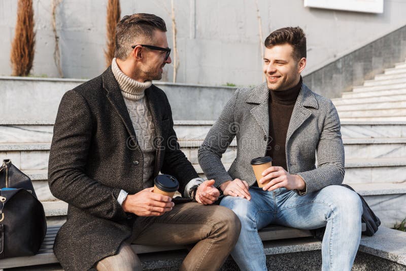 Two Handsome Men Wearing Coats Spending Time Stock Photo - Image of ...