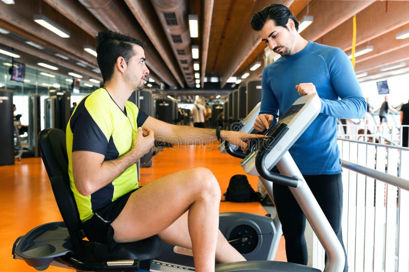 Two Handsome Young Men Doing Cardio Training in Gym. Stock Image ...