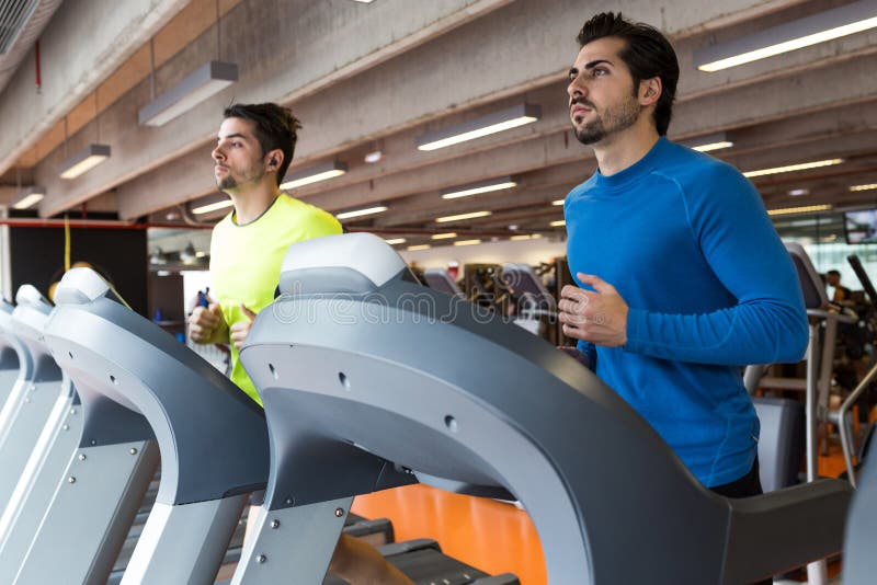 Two Handsome Young Men Doing Cardio Training in Gym. Stock Image ...