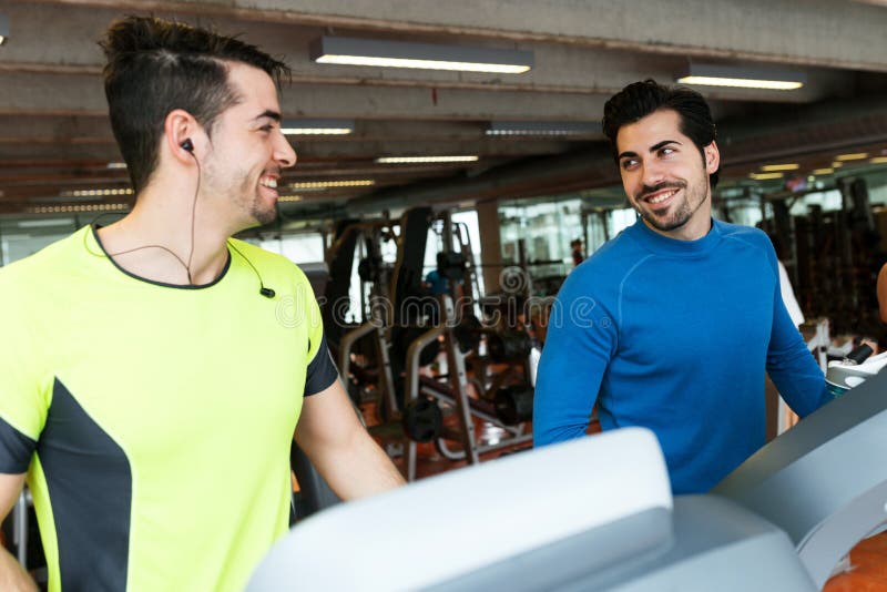 Two Handsome Young Men Doing Cardio Training in Gym. Stock Photo ...