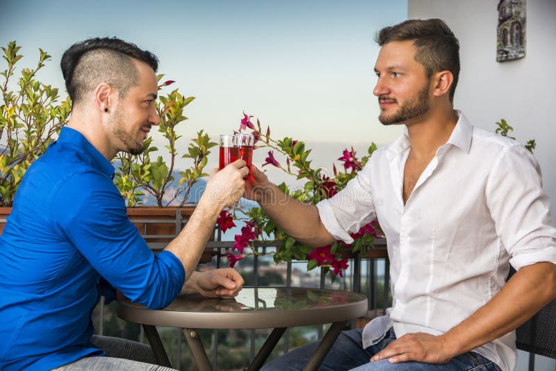 Two Handsome Young Men Sitting at the Table with Wine Stock Image ...