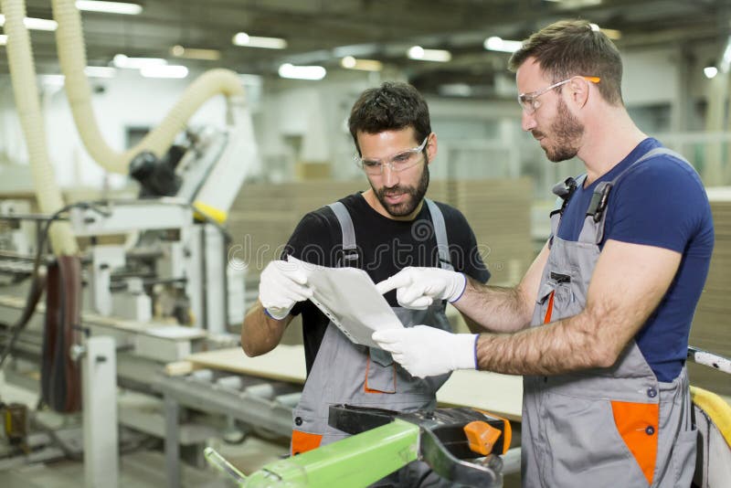 Two handsome young workers stock photo. Image of manufacture - 89479628