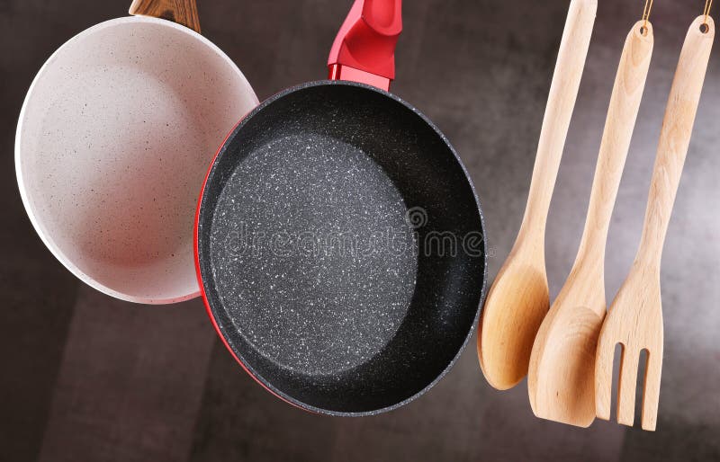 Two Hanging Frying Pans and Kitchen Utensils Stock Image - Image of ...