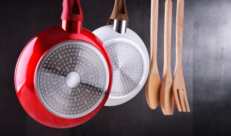 Two Hanging Frying Pans and Kitchen Utensils Stock Photo - Image of ...