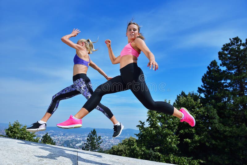 Two Happiness Young Women Jumping Over Blue Sky Stock Image - Image of ...