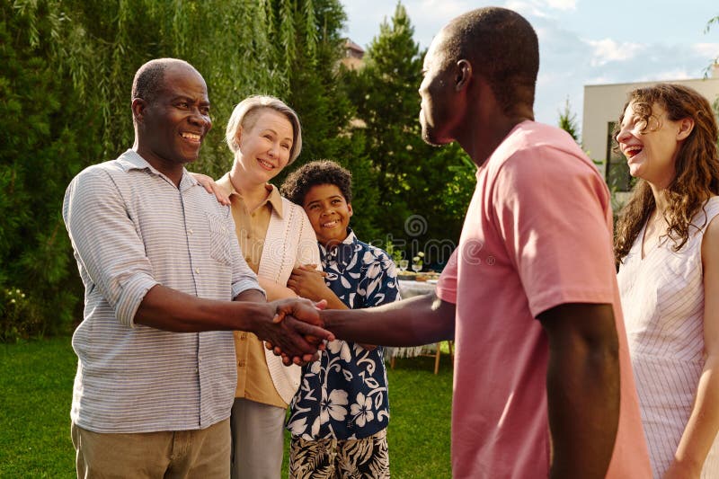 Two Happy African American Men Shaking Hands while Greeting One Another ...