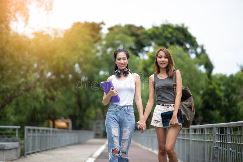 Two Happy Asian Students Talking while Walking in Campus Stock Image ...