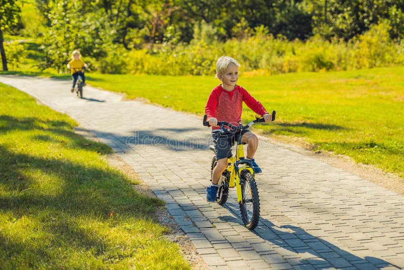 Two Happy Boys Cycling in the Park Stock Image - Image of lifestyle ...