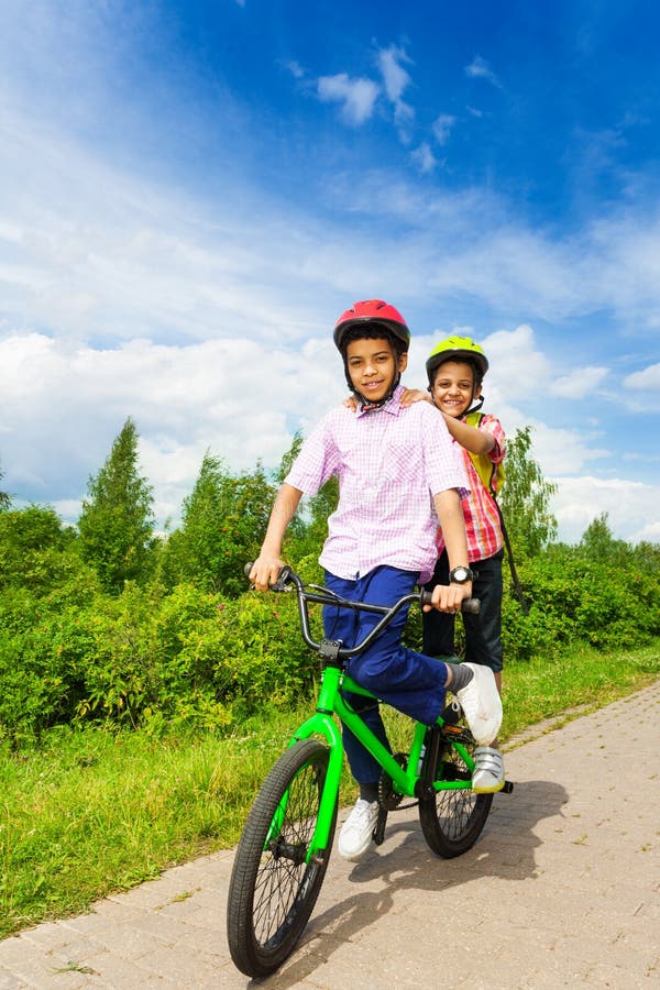 Two Happy Boys Riding Same Bike Both Standing Stock Image - Image of ...