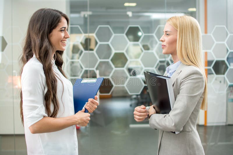 Two Happy Business Women Talking in Office. Stock Photo - Image of ...