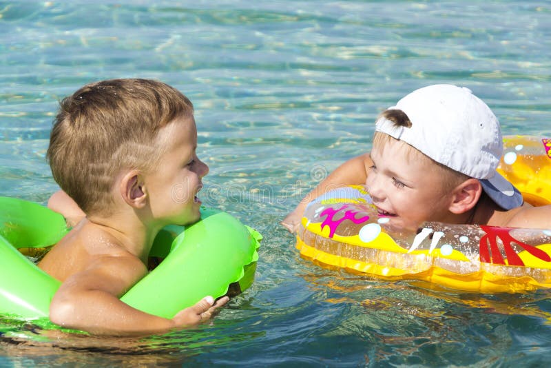 Two Happy Children Having Fun in the Water with Inflateble Ring Stock ...