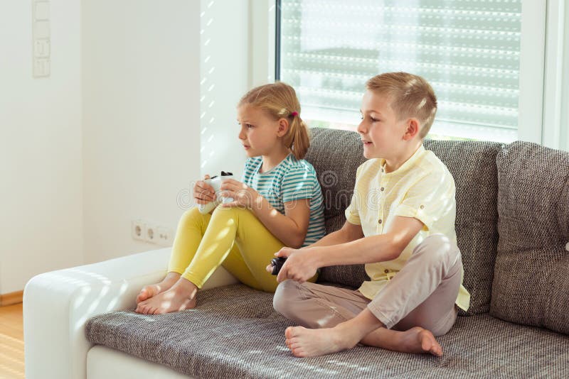 Two Happy Children Playing Video Games at Home Stock Photo - Image of ... Two Happy Children Playing Video Games at Home Stock Photo - Image of ...