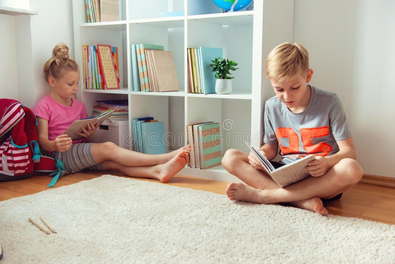 Happy Children Reading Books on the Floor at the School Library Stock ...