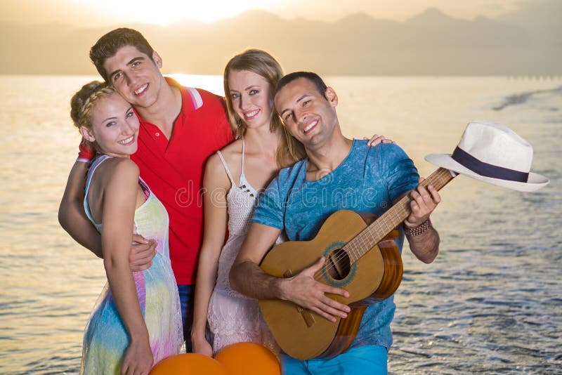 Two Happy Couples at the Beach on Sunset. Stock Photo - Image of ...