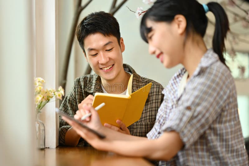 Two Happy Creative People Discussing Ideas Together in a Co Working ...