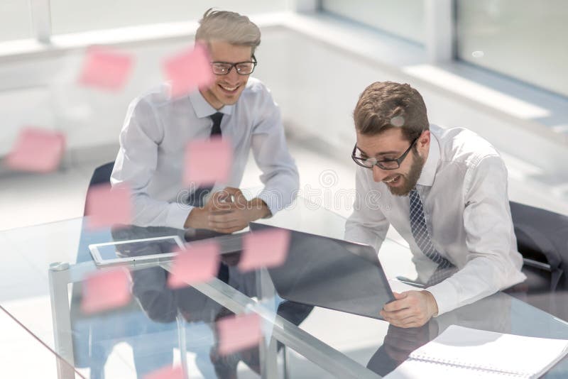 Two Happy Employees Reading a Business Document Stock Image - Image of ...