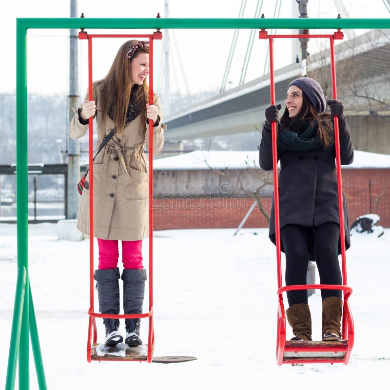 Two Happy Friends on a Swing Stock Photo - Image of caucasian ...