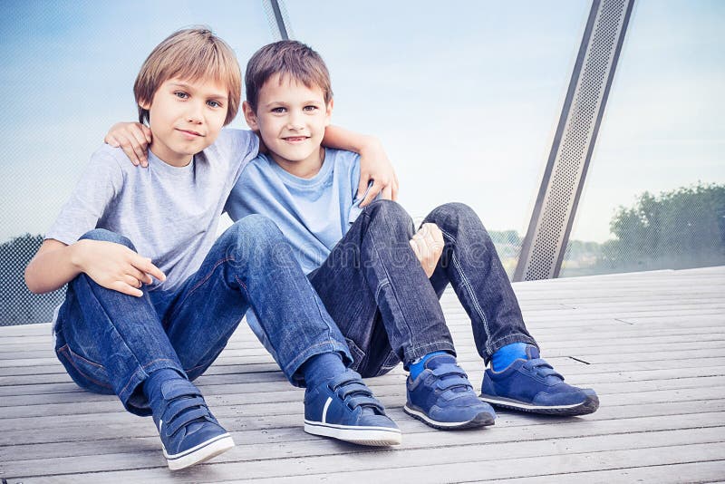 Two Happy Kids Sitting Together and Embracing Stock Photo - Image of ...