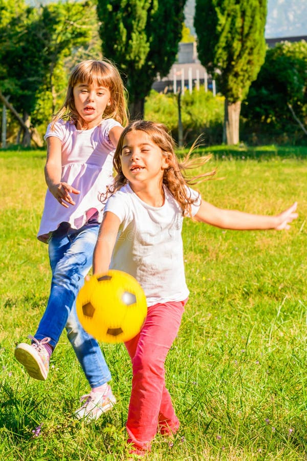 Two Happy Little Girls Playing In The Park Stock Image - Image: 47008889