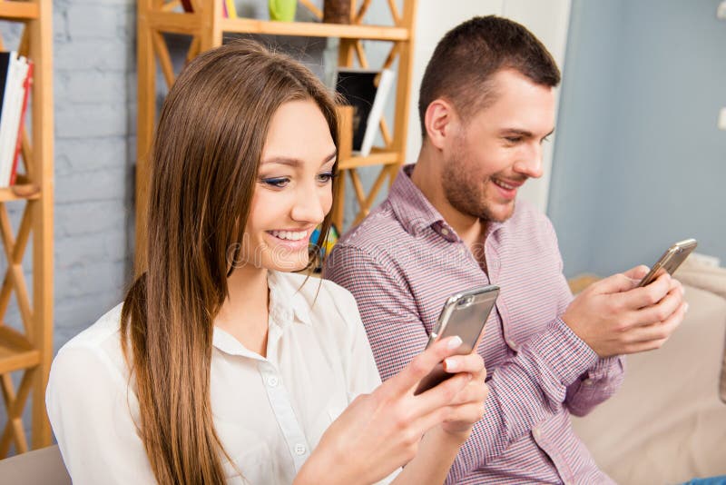 Two Happy Lovers with Mobile Phones Typing Messages Stock Photo - Image ...