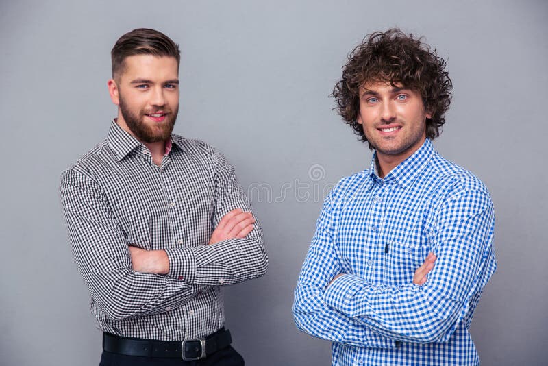 Two Happy Men Standing With Arms Folded Stock Photo - Image of ...