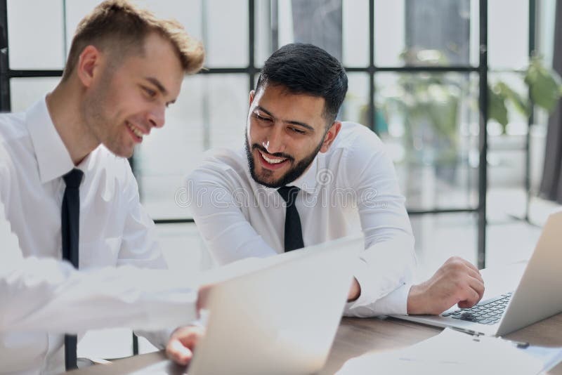 Two Happy Men Working Together on a New Business Project Stock Photo ...