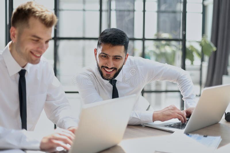 Two Happy Men Working Together on a New Business Project Stock Photo ...