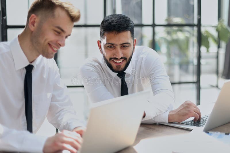 Two Happy Men Working Together on a New Business Project Stock Photo ...
