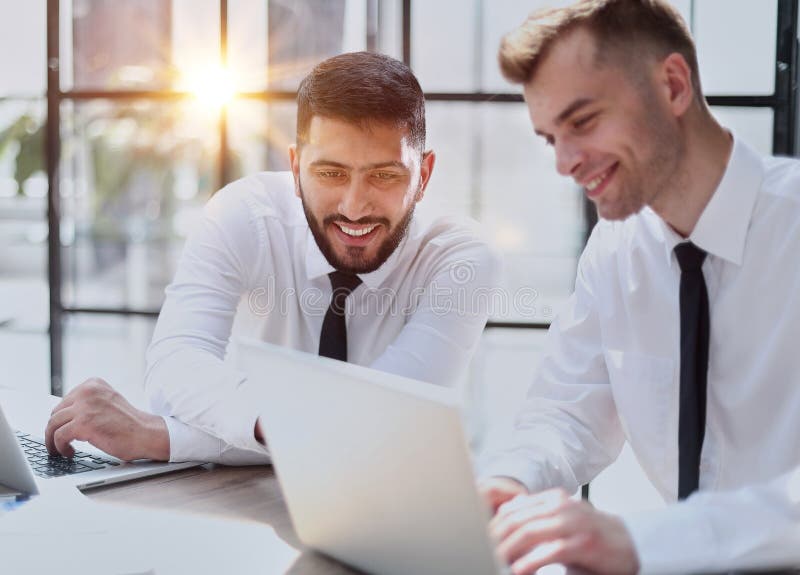 Two Successful Smiling Businessmen are Working on a Laptop. View from ...