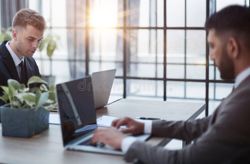 Two Successful Smiling Businessmen are Working on a Laptop. View from ...