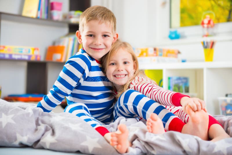 Two Happy Siblings in Sleepwears in Bed Stock Image - Image of interior ...